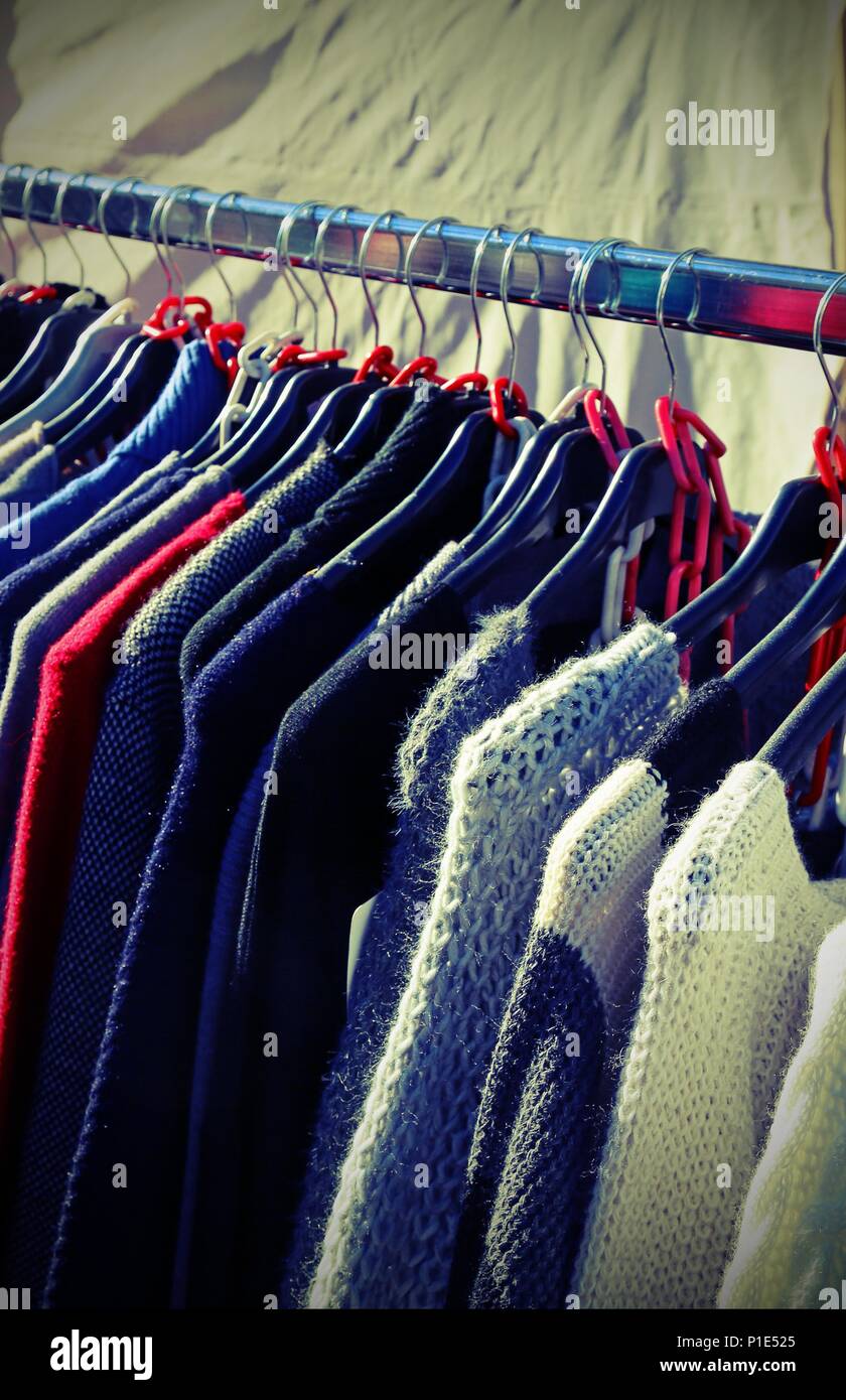 clothes on hangers at the outdoor market with vintage effect Stock ...