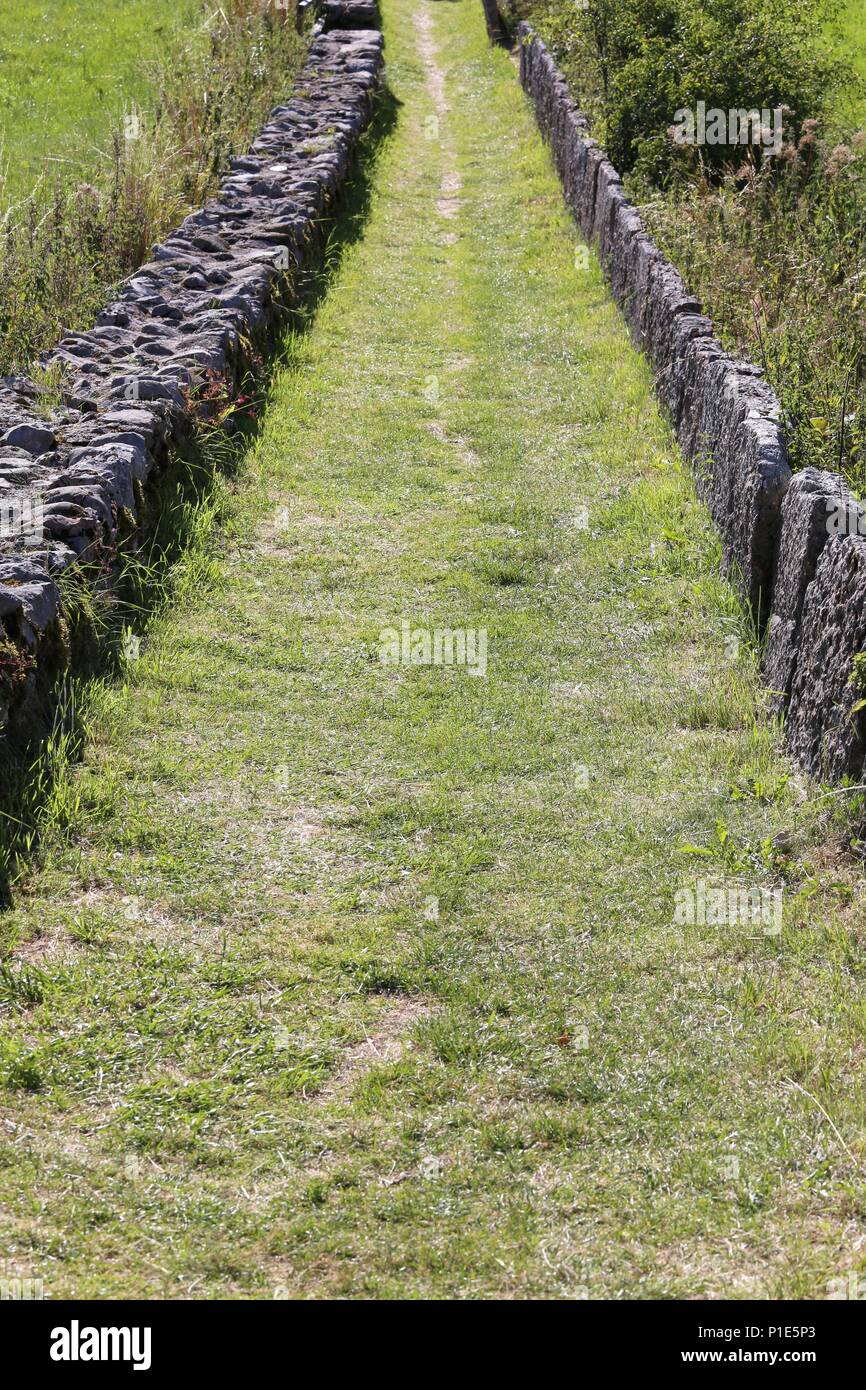 long mountain path bordered by stone slab Stock Photo - Alamy