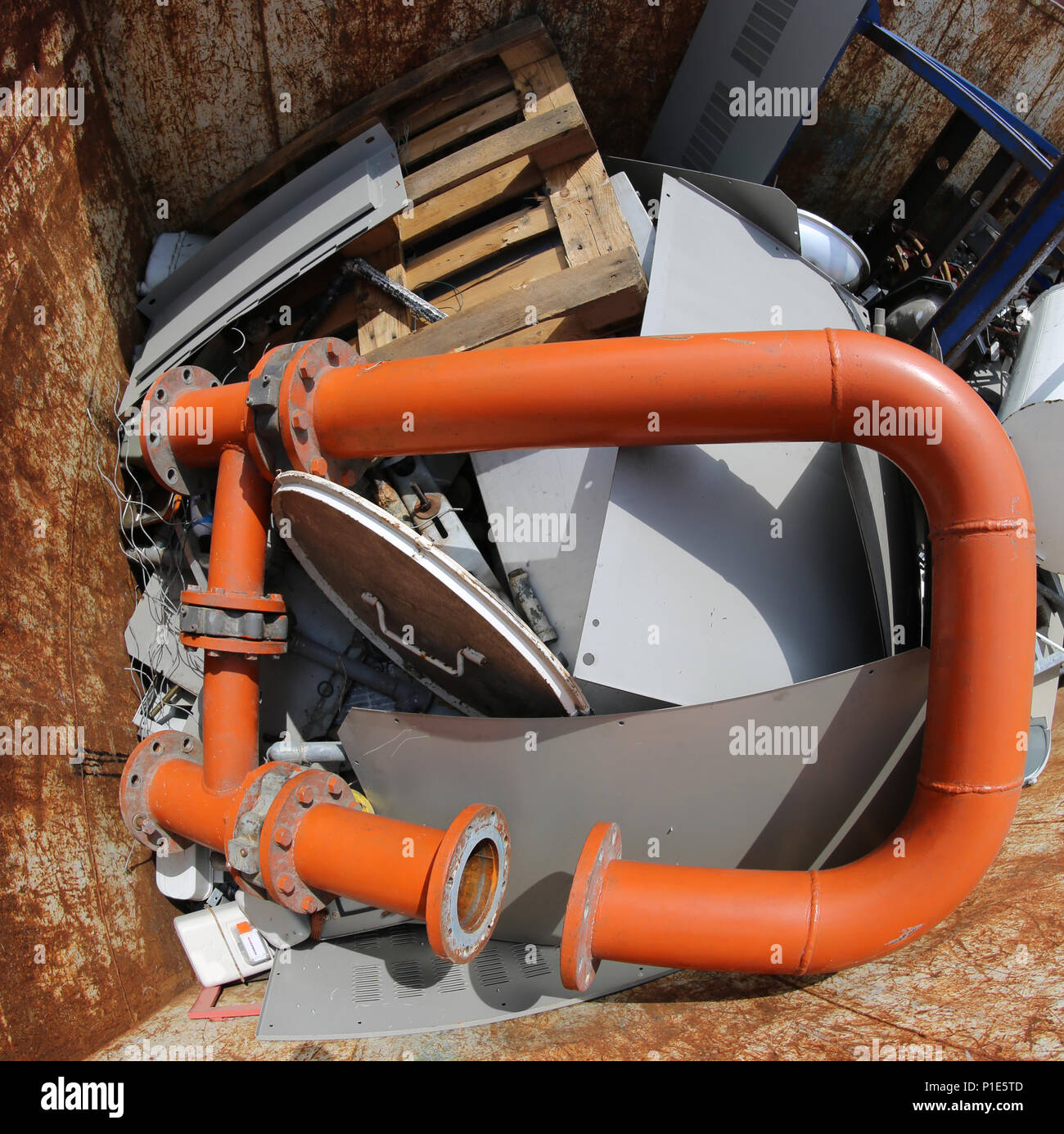 huge orange pipe in the container with many exhausted materials Stock ...