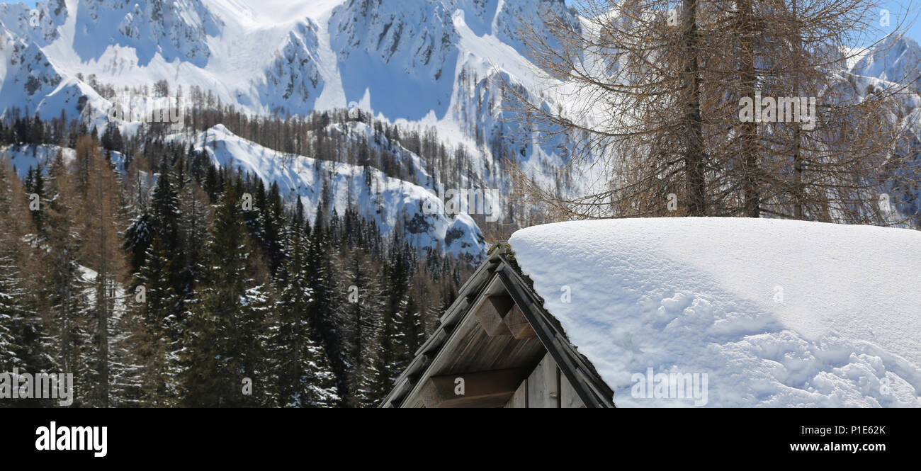 roof of a small hut with snow and mountains in background Stock Photo ...