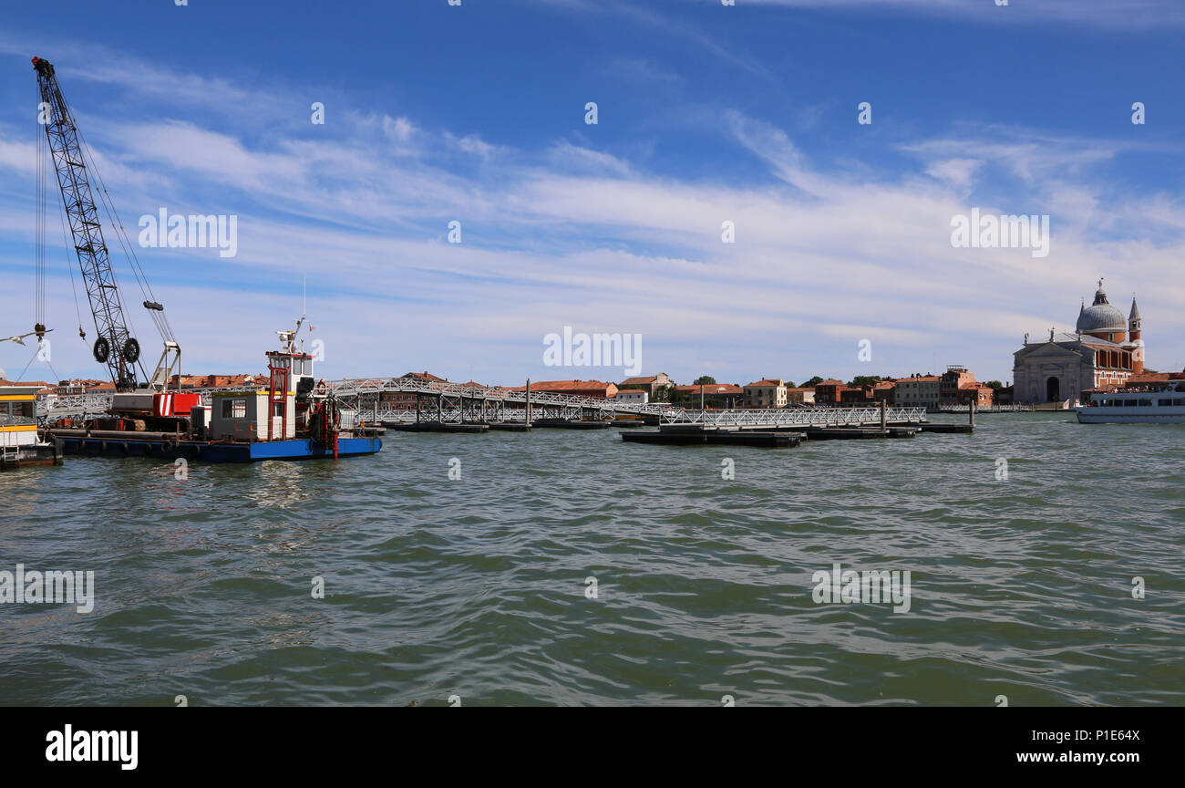 Shipyard during the construction of a floating bridge made with boats ...