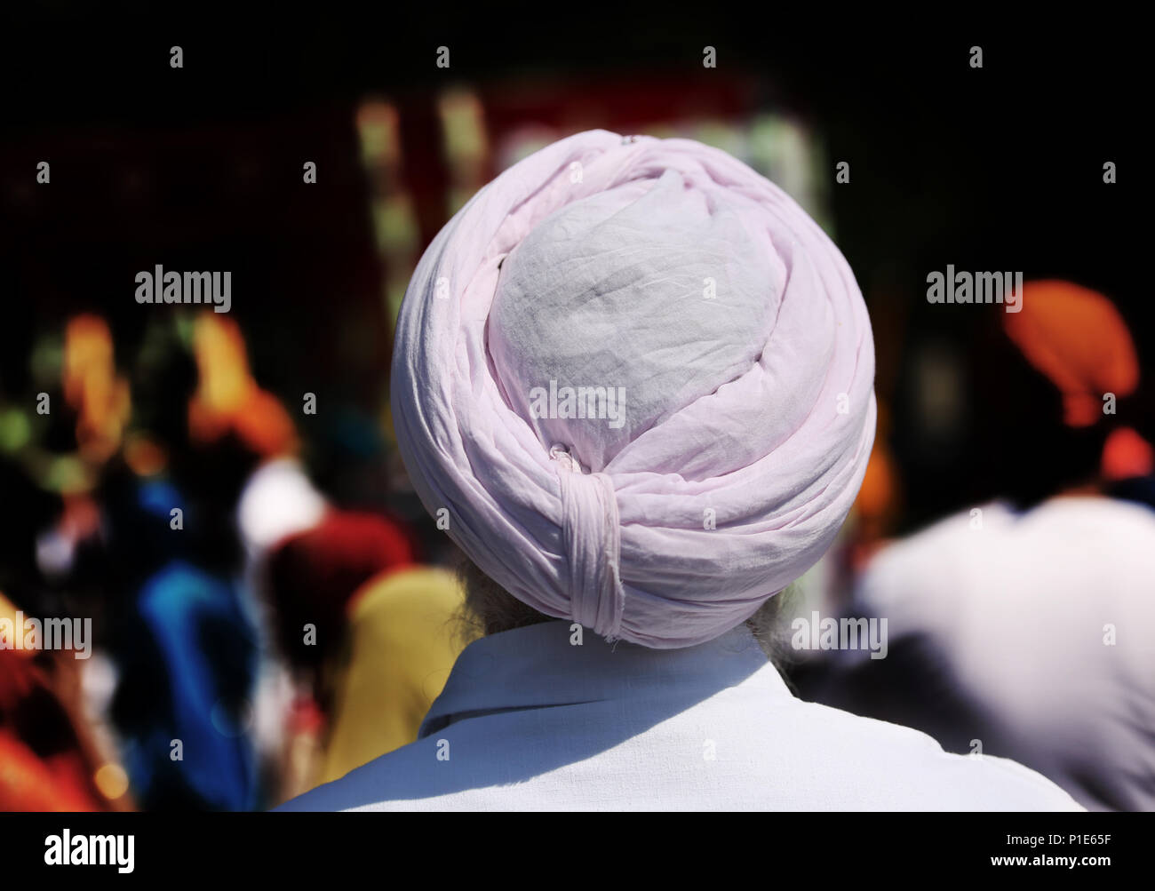 Sikh man with pink turban during the religious rite and high contrast ...