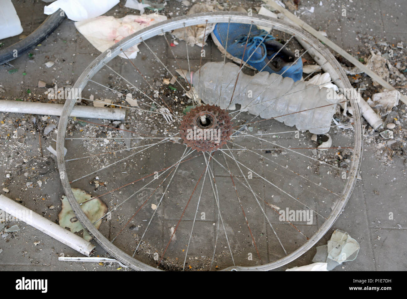 rusted rim wheel of a broken bike without the tire in the trashes Stock ...