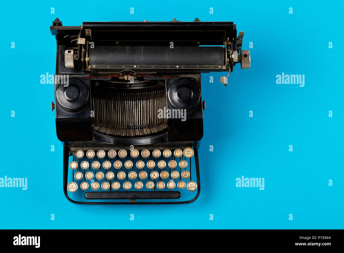 Vintage typewriter top down flatlay shot from above on cyan background ...
