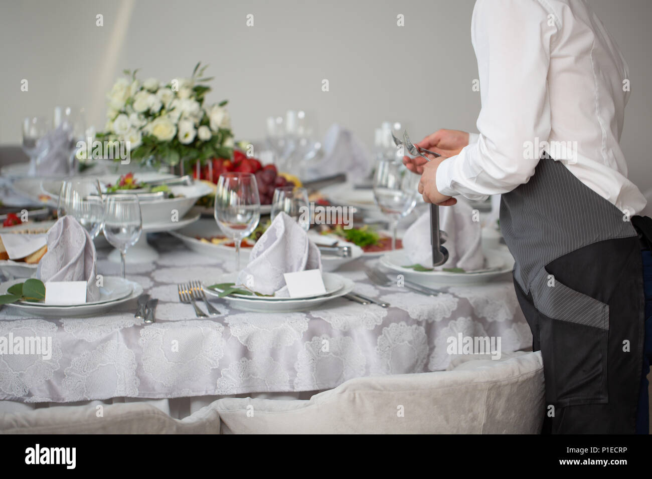 Restaurant waiter serving table with food. Wedding table Stock Photo ...