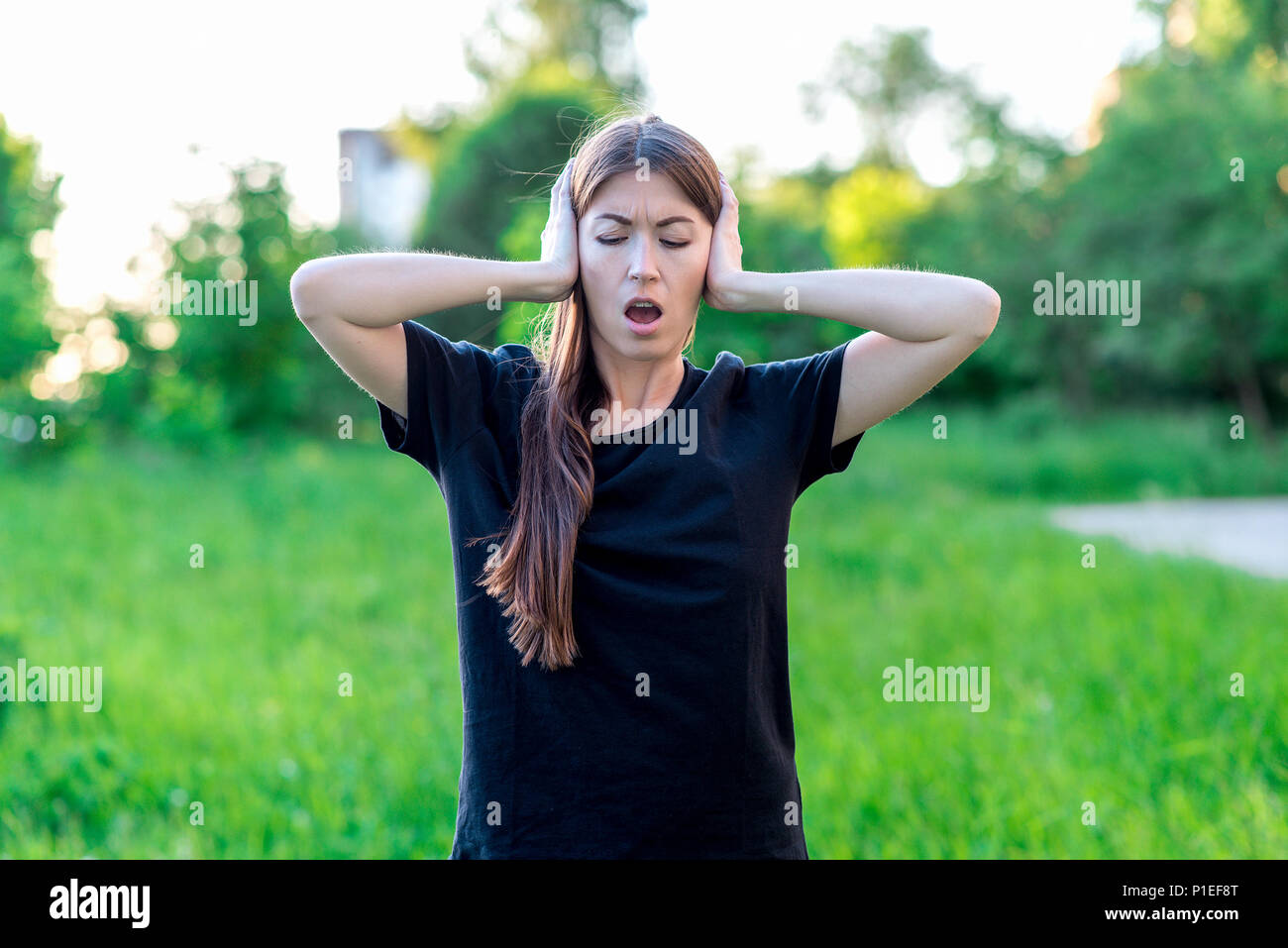 Girl summer in fresh air. I closed my ears with my hands and opened my ...