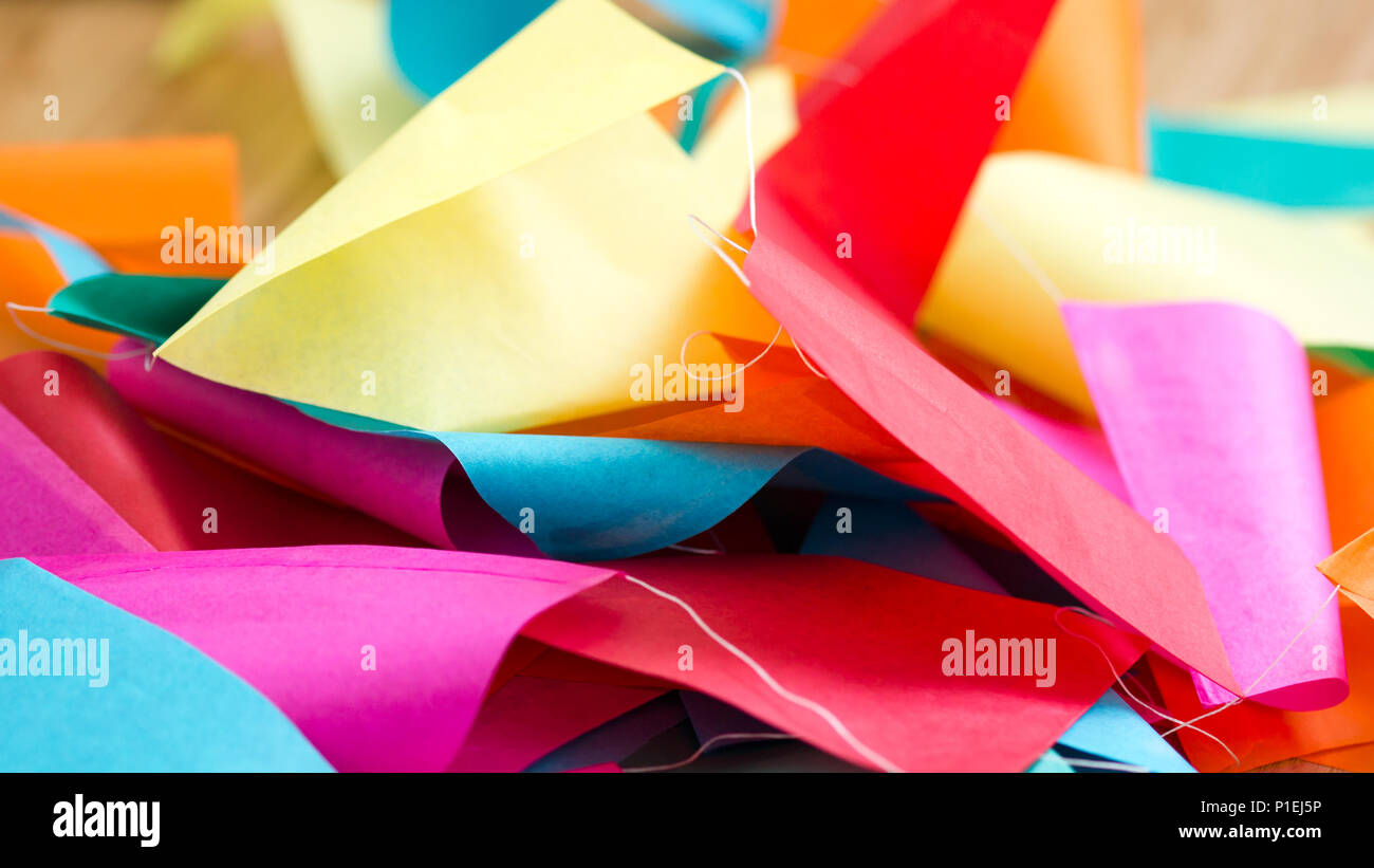 Tangled, crumpled bunting (party decorations). Colorful, blurry ...