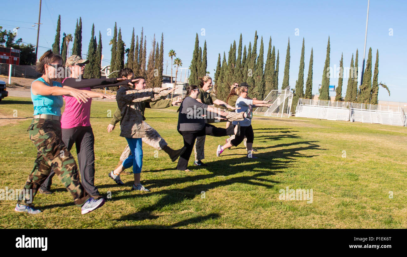Military spouses perform warm-up exercises, including the Frankenstein ...