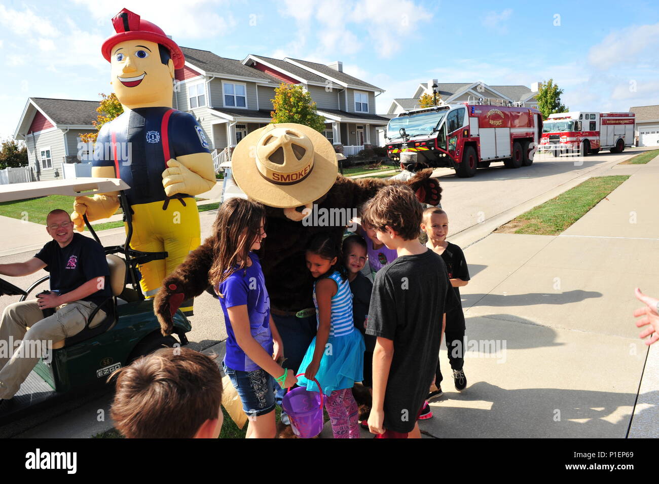 Smokey the Bear, a fire prevention mascot, stands with members of Team ...