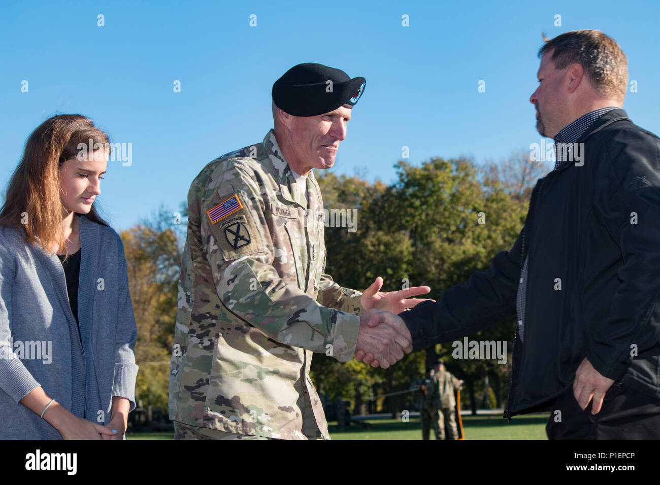 First Army’s Command Sgt. Maj. Sam K. Young and his family shake hands ...