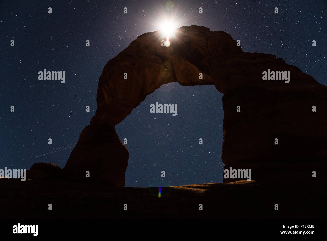 Delicate Arch at Arches National Park lit up by the moon against the ...