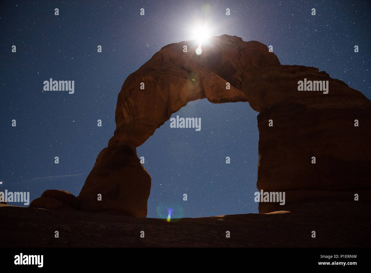 Delicate Arch at Arches National Park lit up by the moon against the ...