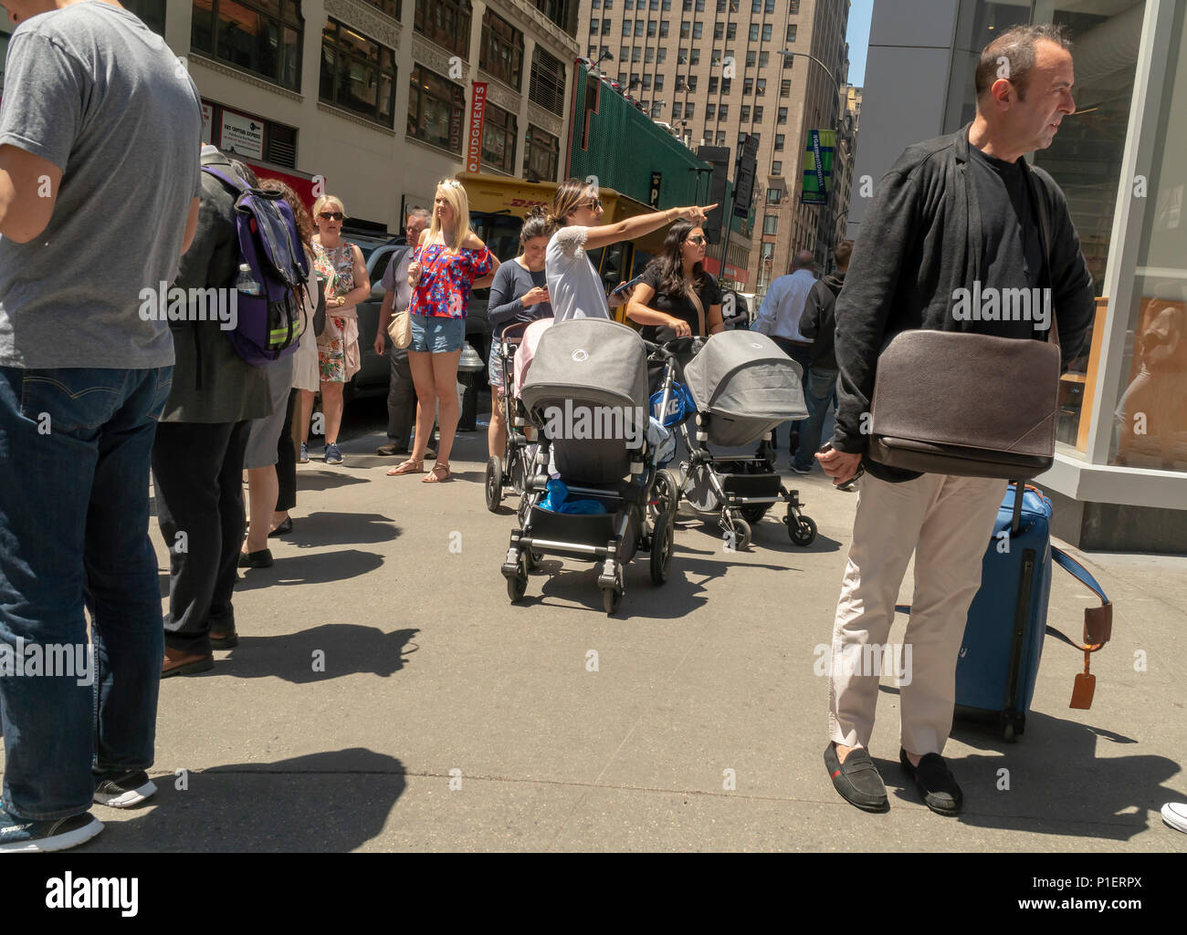 Stroller gridlock on a busy street corner in the Garment District in ...