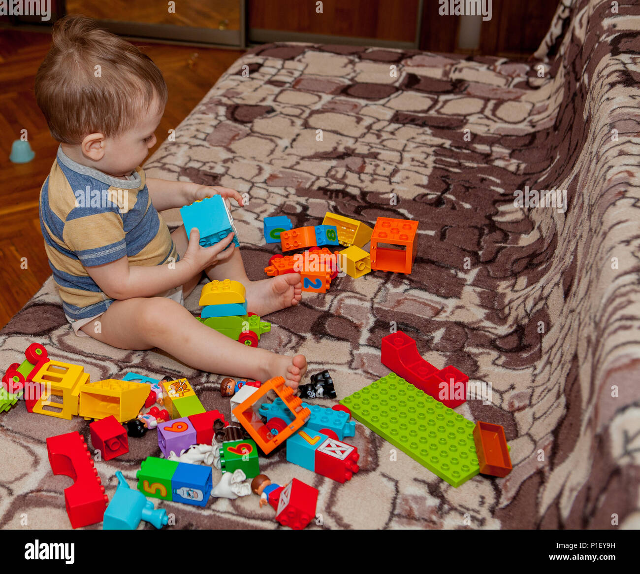 Sweet little boy building tower from cubes at home Stock Photo - Alamy