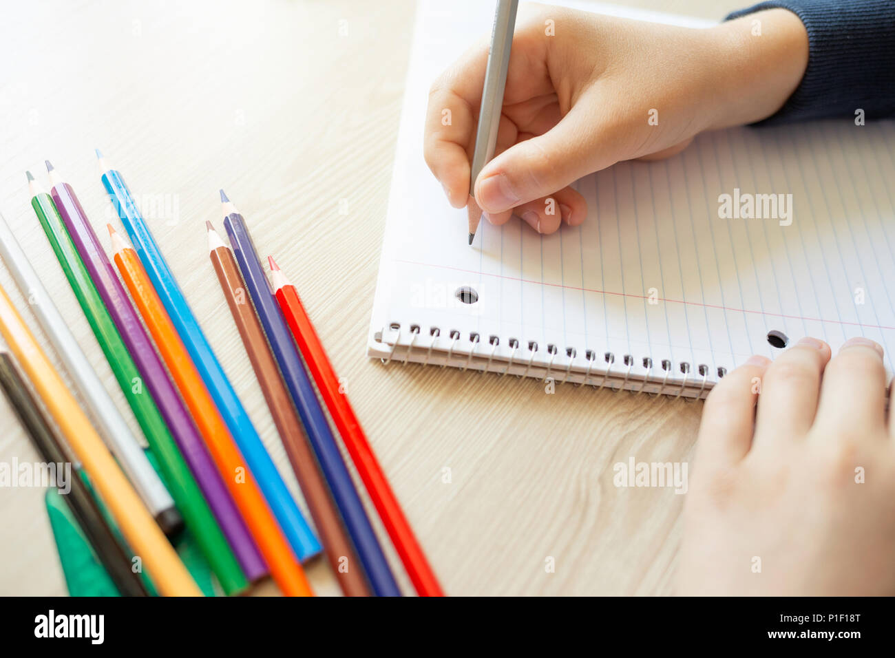 Student hand with pencil on desk hi-res stock photography and images - Alamy