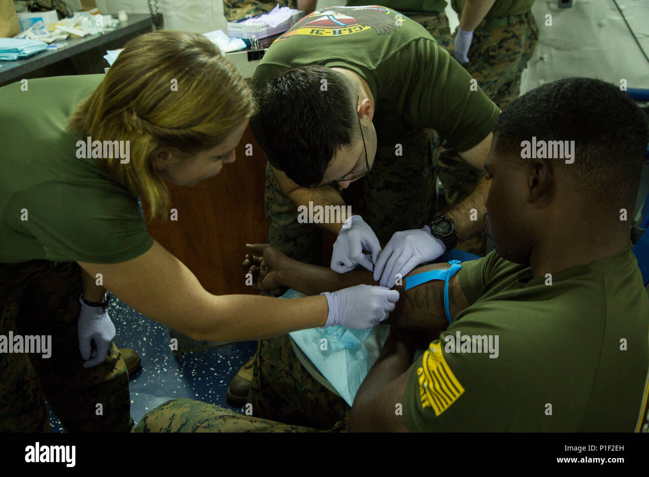U.S. Marine Corps Lt. Sarah Faris, left, oversees Sgt. William ...