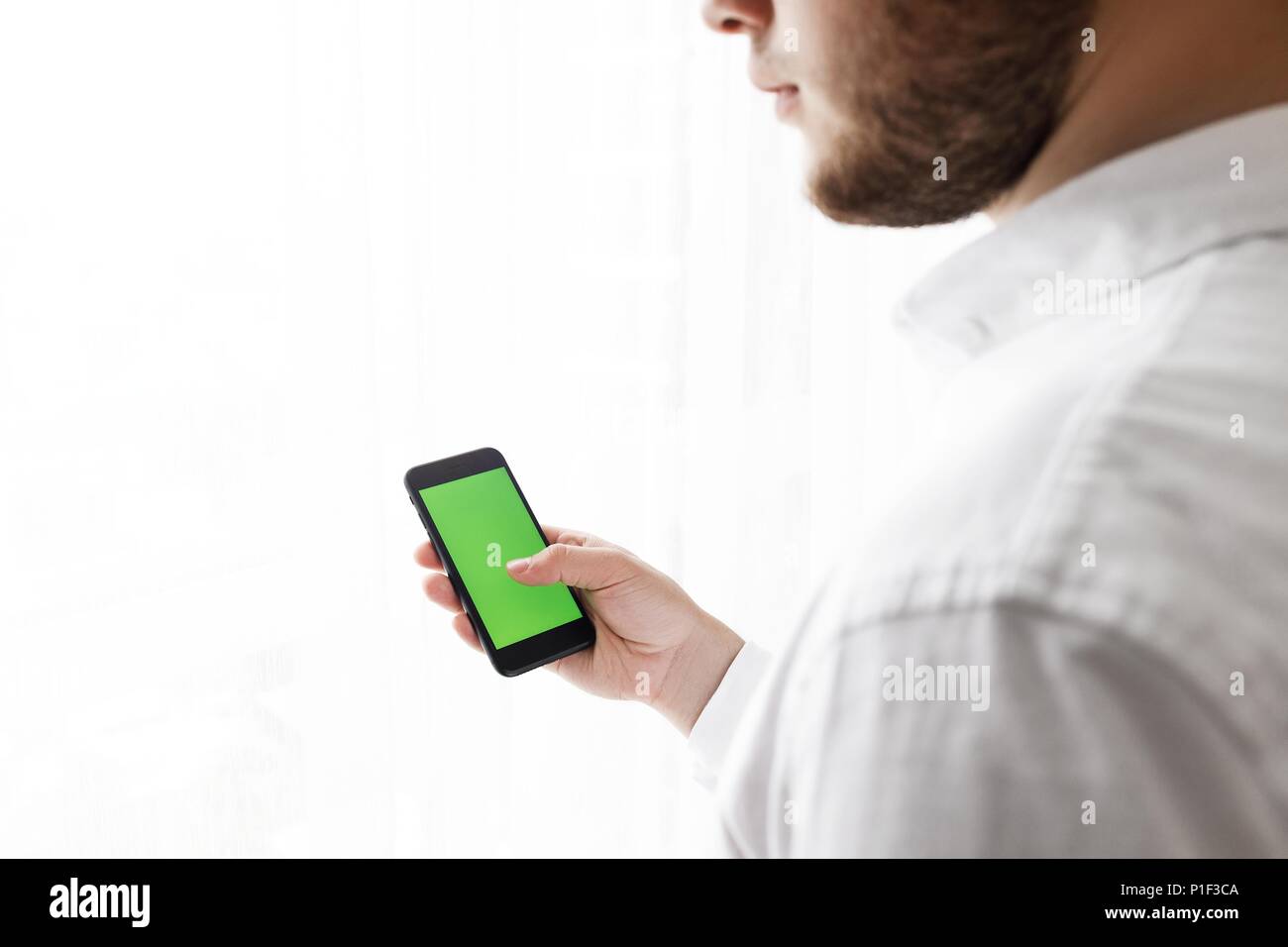 Man using mobile phone while standing near window. Chroma key Stock ...