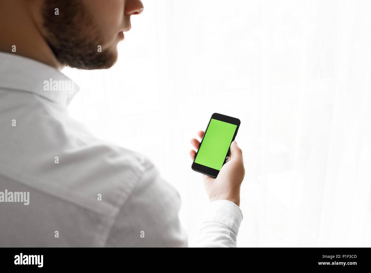 Man using mobile phone while standing near window. Chroma key Stock ...