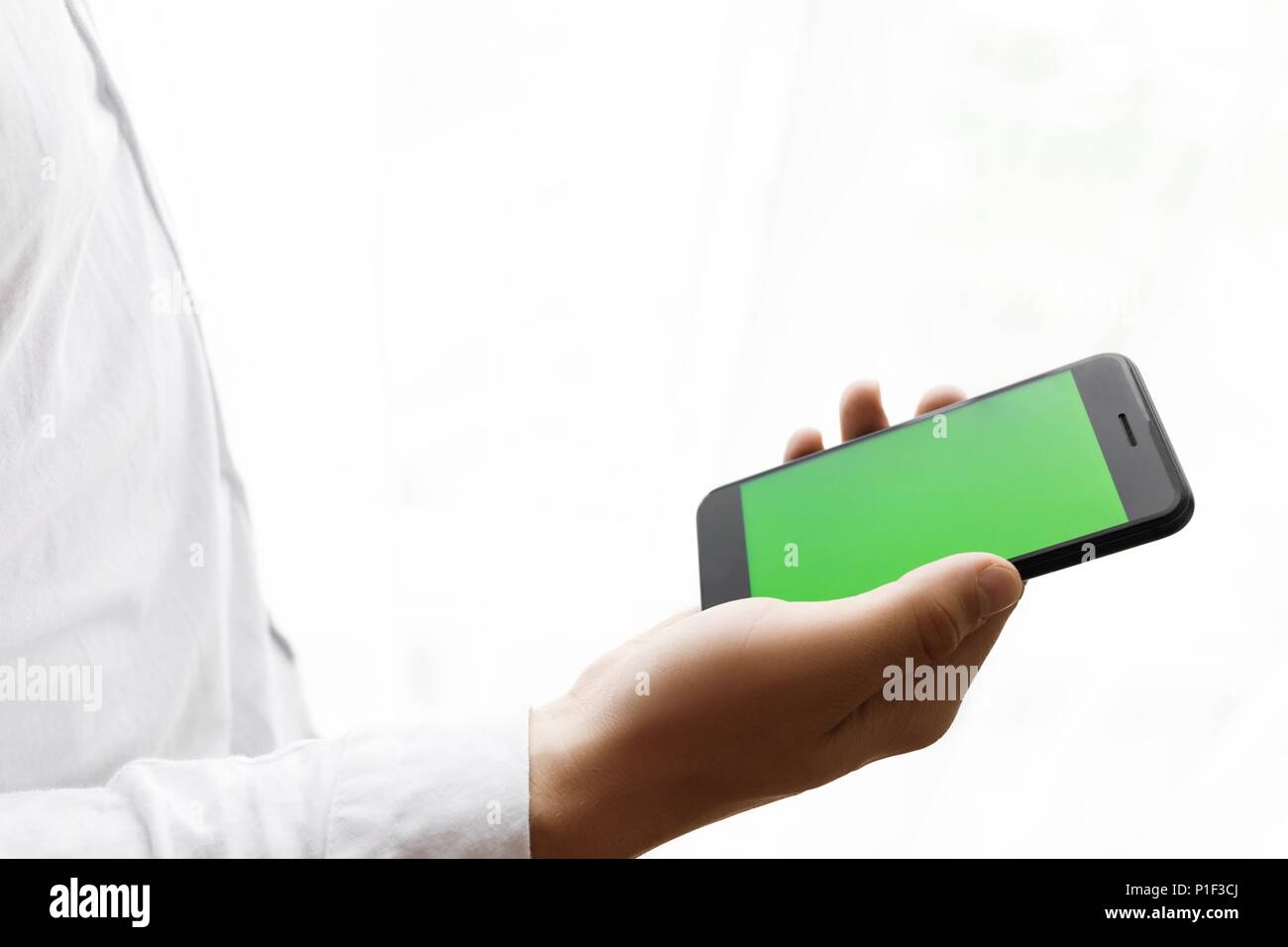 Man using mobile phone while standing near window. Chroma key Stock ...