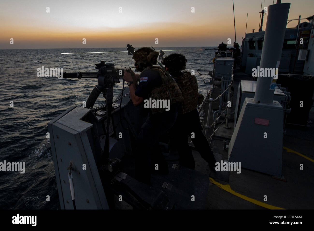 161021-N-SB587-1238 Sailors with the Royal navy fire a M134 minigun and ...