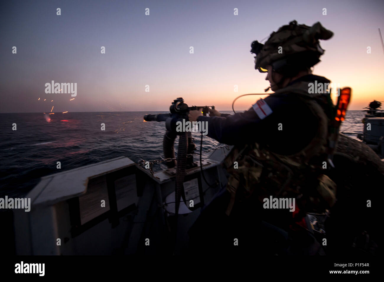 161021-N-SB587-1369 A sailor with the Royal navy fires a M134 minigun ...