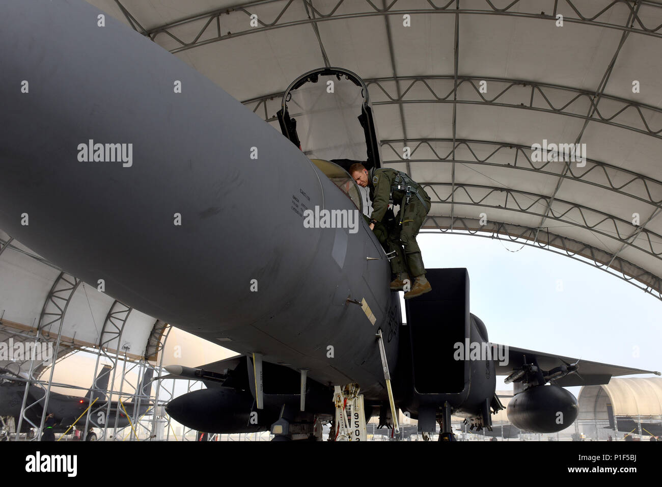 A U.S. Air Force pilot from the 336th Fighter Squadron boards an F-15E ...