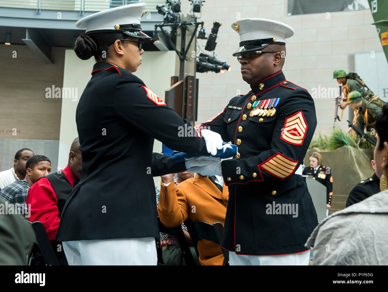 U.S. Marine Corps Gunnery Sgt. Lennel T. Johnson receives a U.S. flag ...