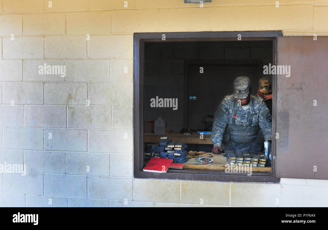 Soldiers assigned to 16th Military Police Brigade load magazines at the ...