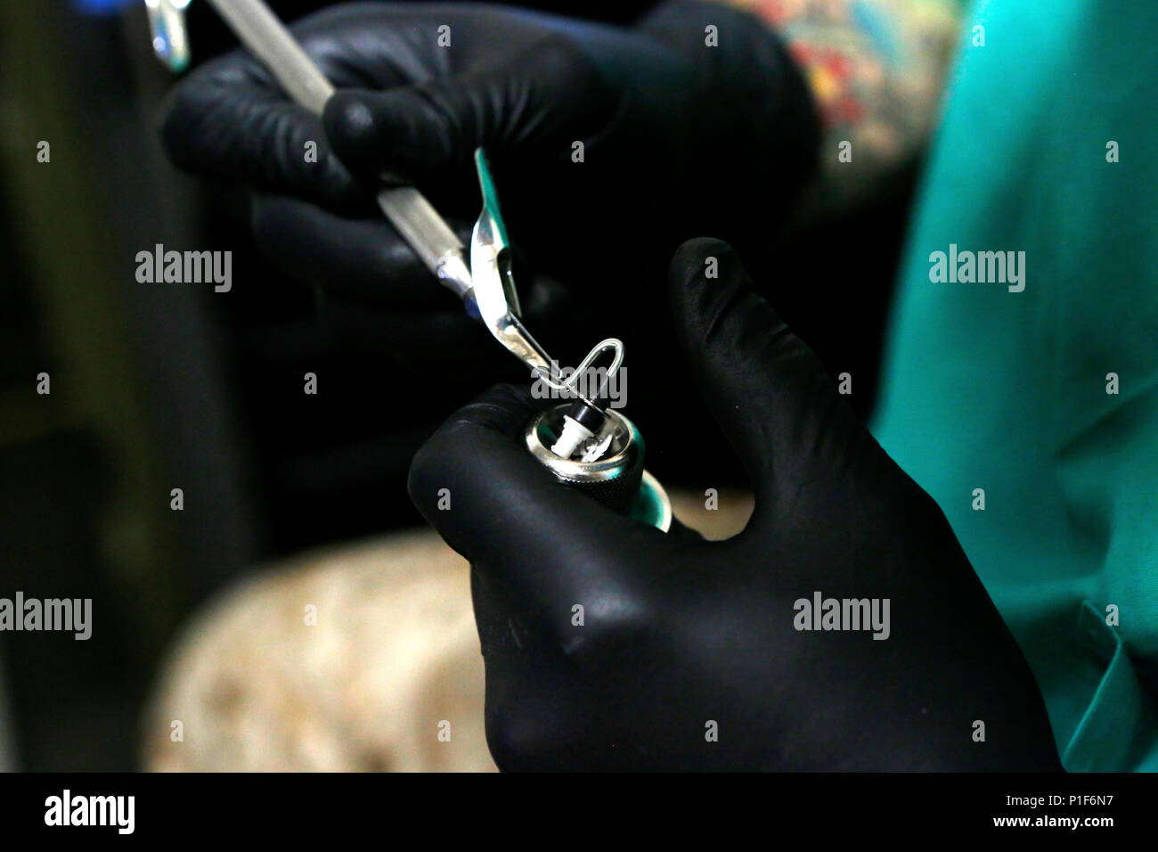 U.S. Navy Seaman James Pytel prepares a dental filling during the ...