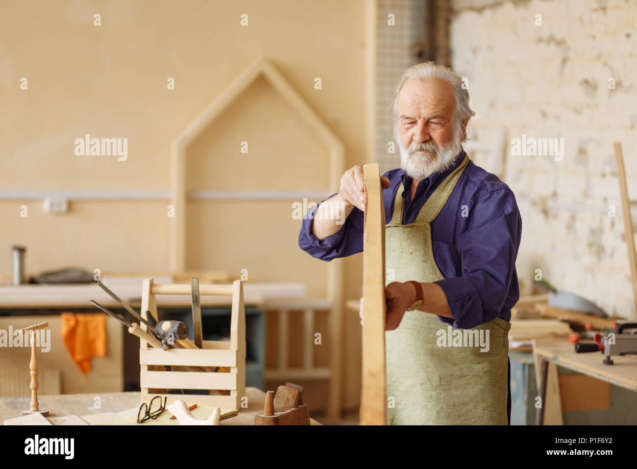 old craftsman with grey hair, moustache and beard moving planks Stock ...