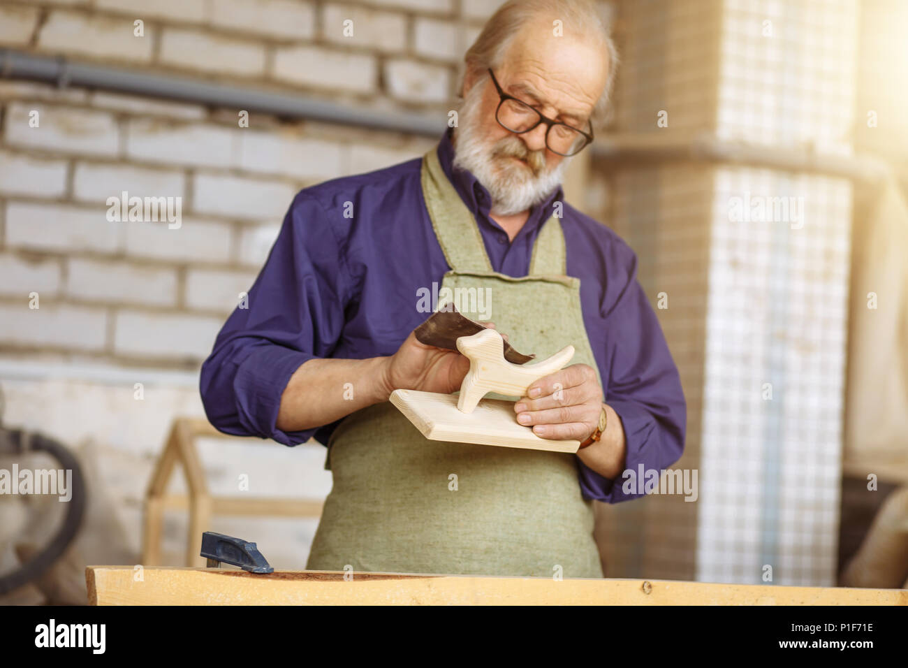 old carpenter working with glasspaper Stock Photo - Alamy