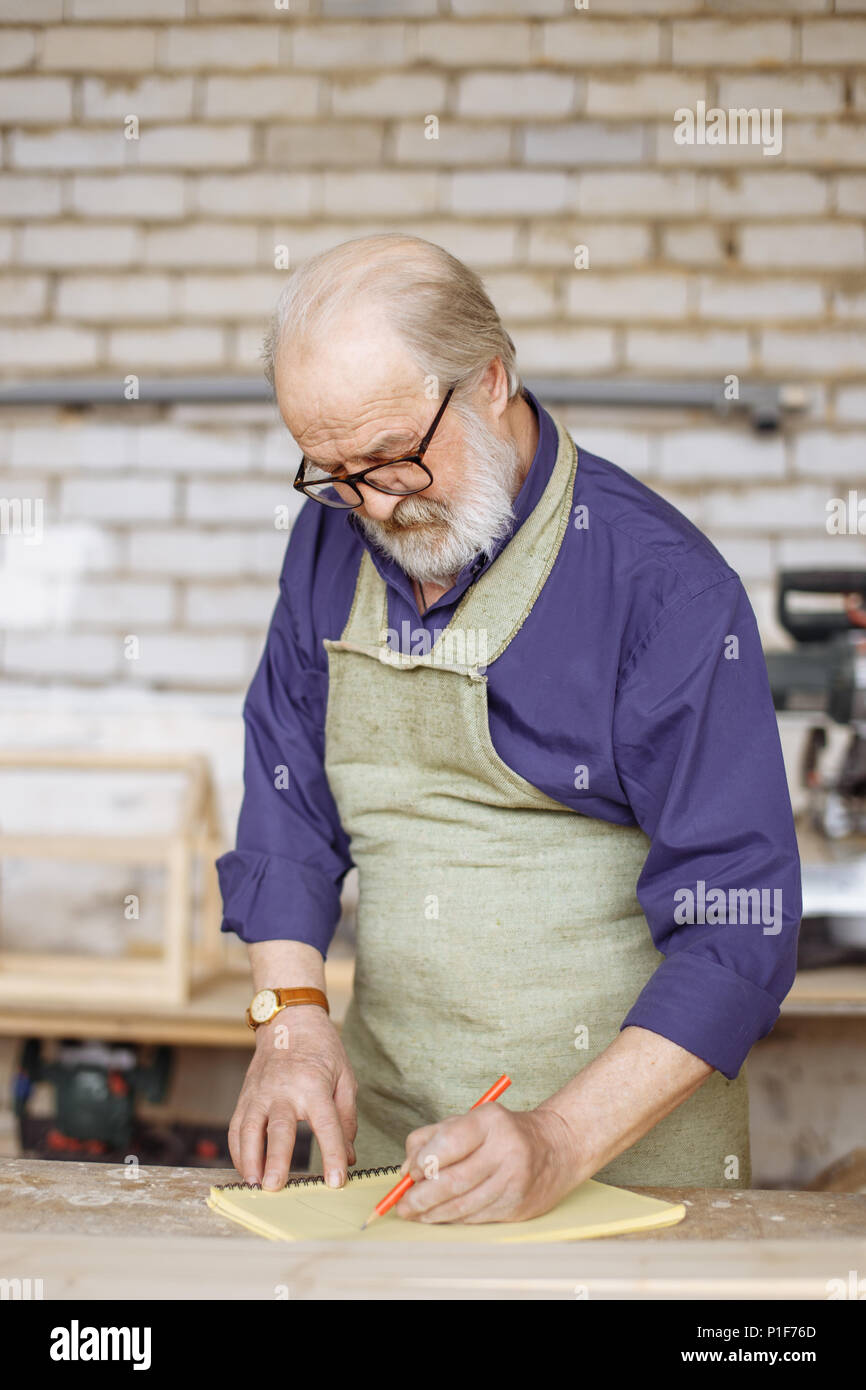 talented old man is working in the workroom Stock Photo - Alamy