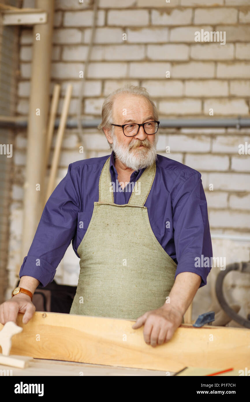 old hardworking man making wood construction in garage Stock Photo - Alamy