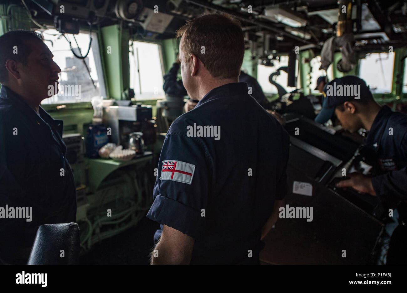 Commanders of USS Gladiator (MCM-11) and RFA Lyme Bay (L 3007) exchange ...