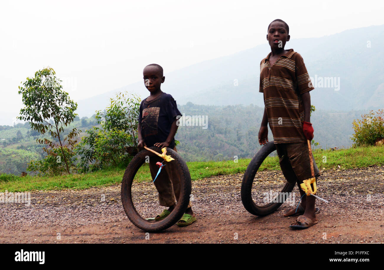 Rwandan boys playing with motorbike tires in rural Rwanda Stock Photo ...