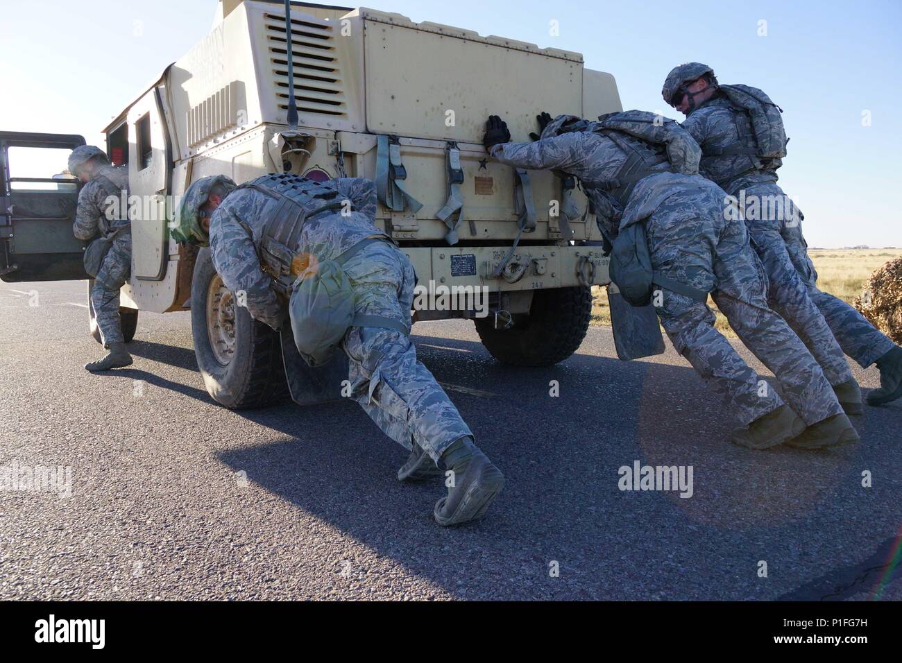 Members of 377th Weapons Systems Security Squadron push a Humvee during ...
