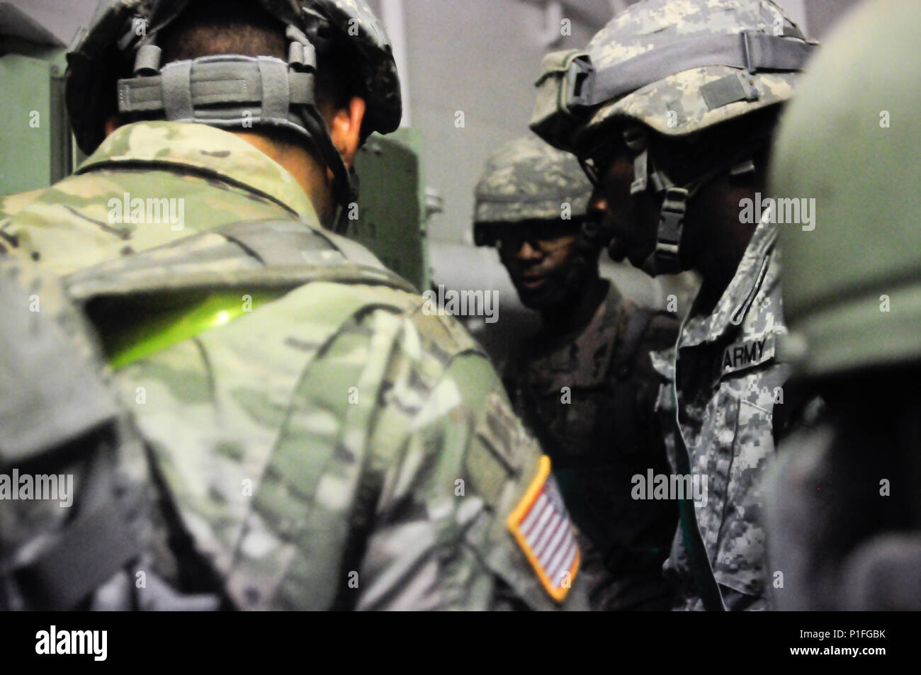 Patriot Soldiers inspect the engine compartment of the Cape Trinity ...