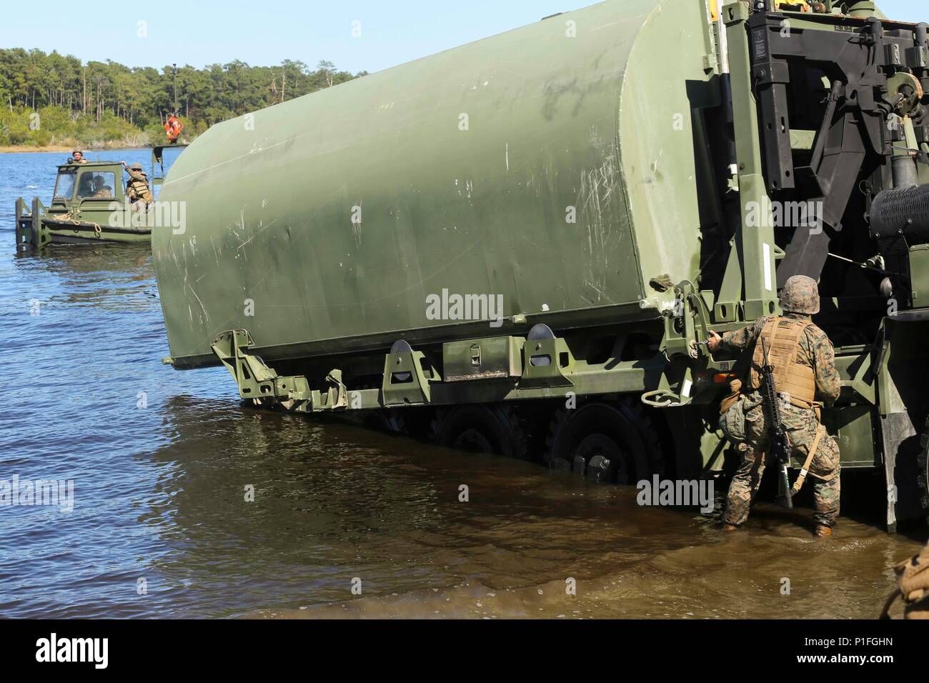 Lance Cpl. Jordan Miller calls commands while releasing the lever that ...