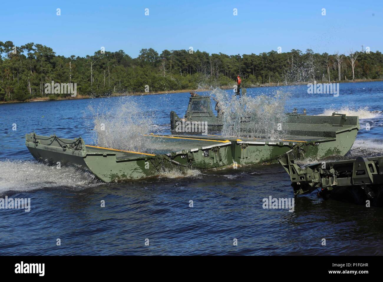 Marines deliver part of an improvised ribbon raft to be interlocked ...