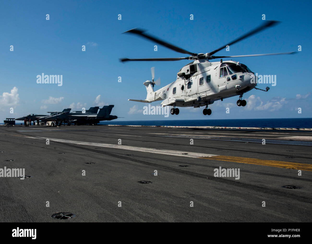 A Japanese MCH-101 airborne mine countermeasures helicopter carrying ...