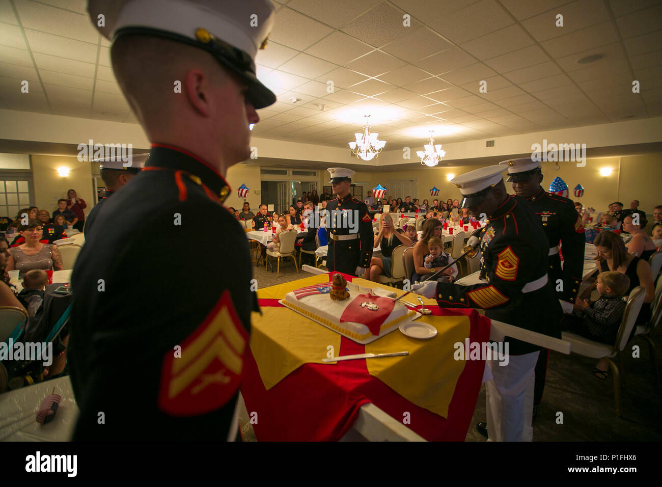 Sgt. Maj. Christopher Edmondson cuts the cake for the oldest and ...