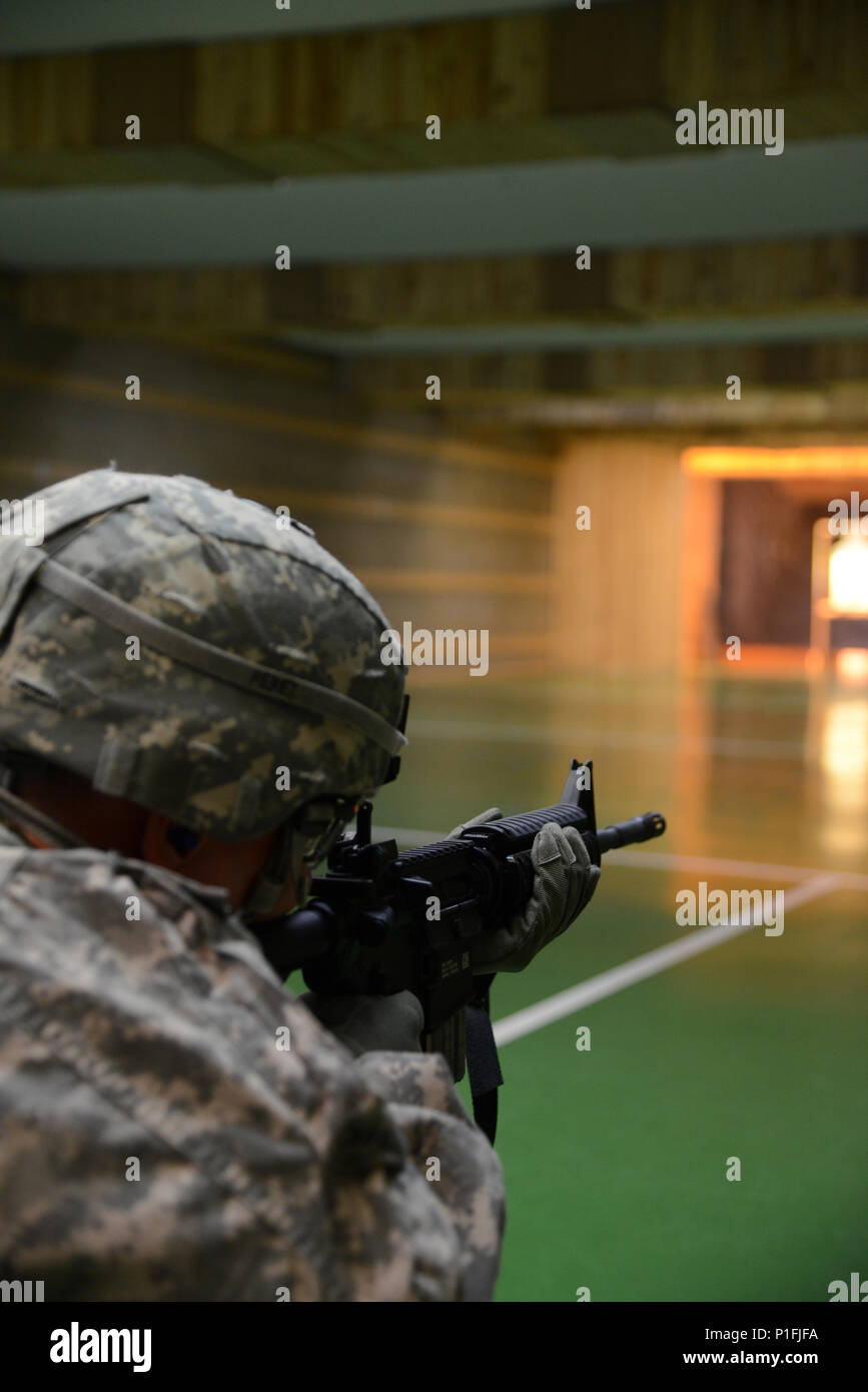 U.S. Army Spc. Gabriel Perez, assigned to 39th Signal Battalion, aims ...