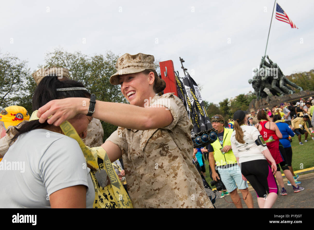 A U. S. Marine lieutenant gives finisher medals to participants of the ...