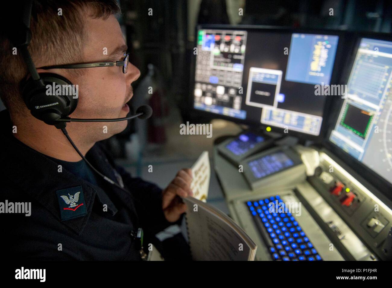 A radar systems controller aboard the pre-commissioning unit John Finn ...