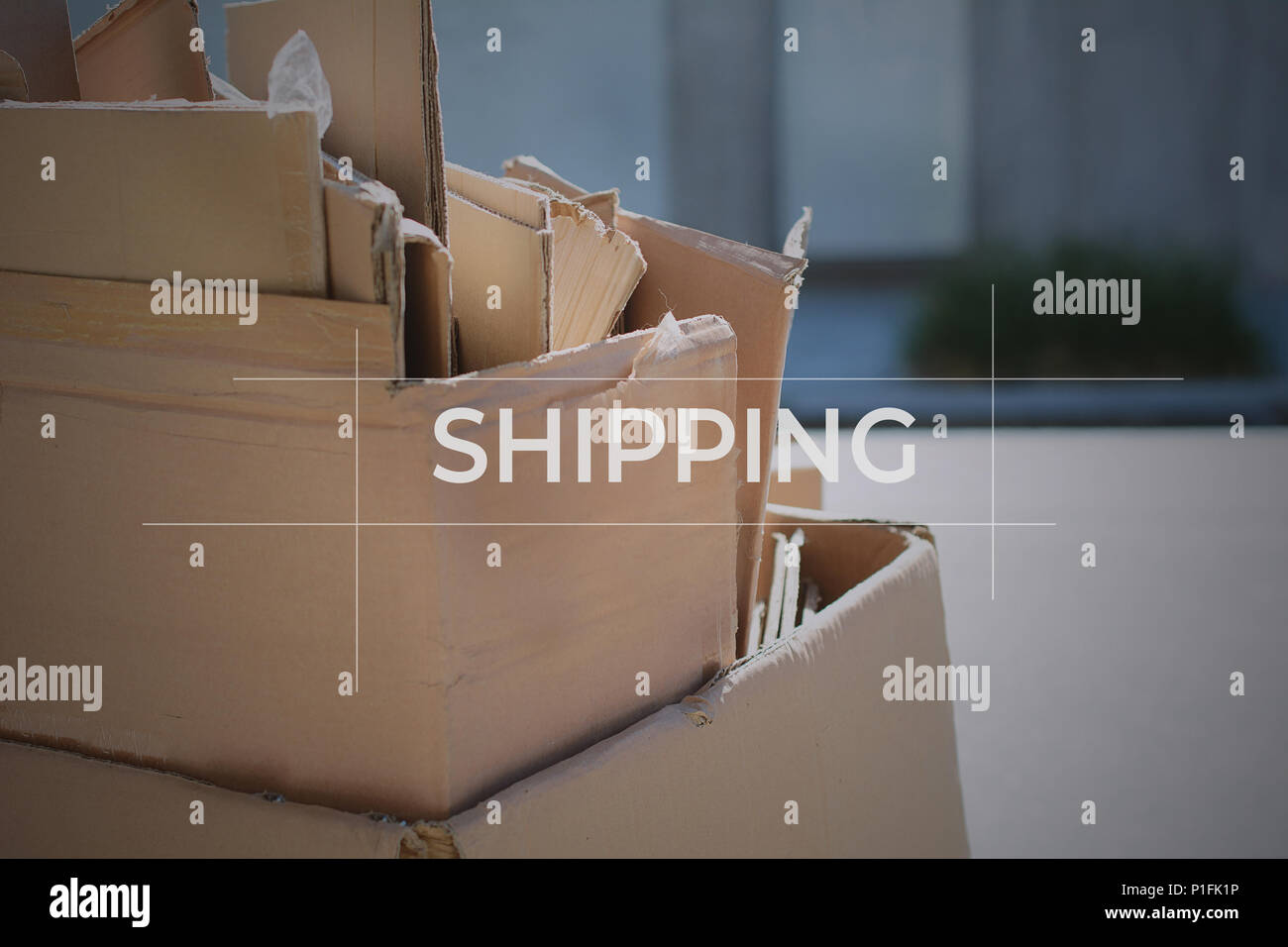 Several cardboard boxes with focus on "shipping" text. Outdoors. Cargo ...