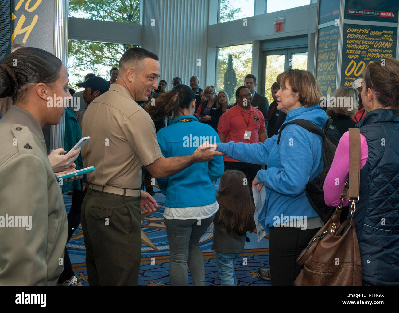 U.S. Marine Corps Col. Joseph Murray greets attendees entering the ...