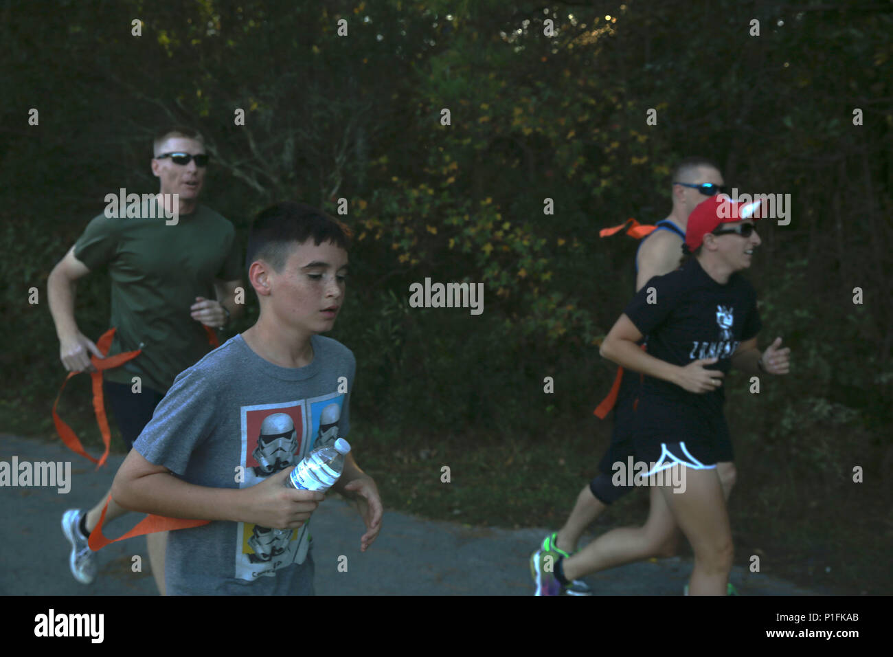 Col. Russell Burton runs with his son Jake Burton and other runners ...