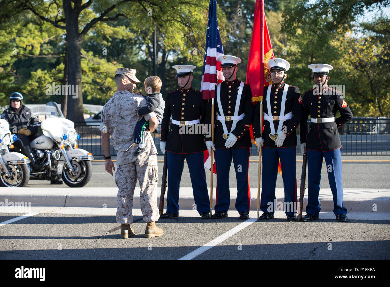 Marine Col. Joseph M. Murray shows a child the Marine Corps Color Guard ...