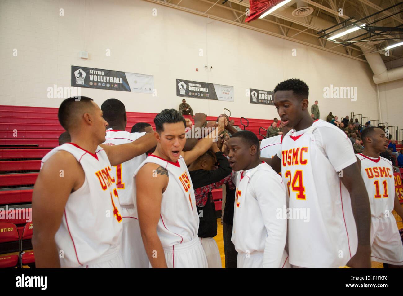 Members of the U.S. Marine Corps basketball team break from the huddle ...