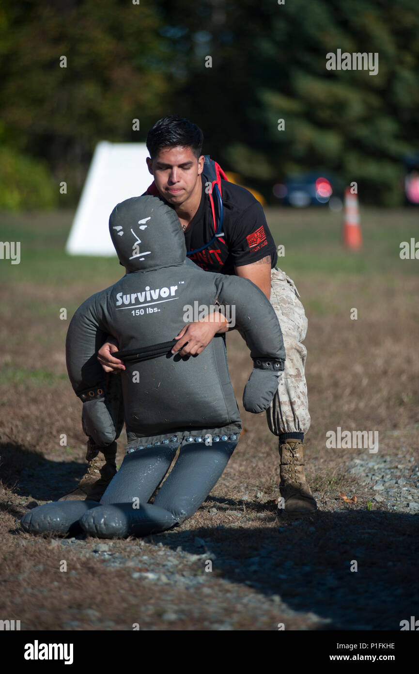 A dog handler performs a buddy drag during the obstacle course for the ...